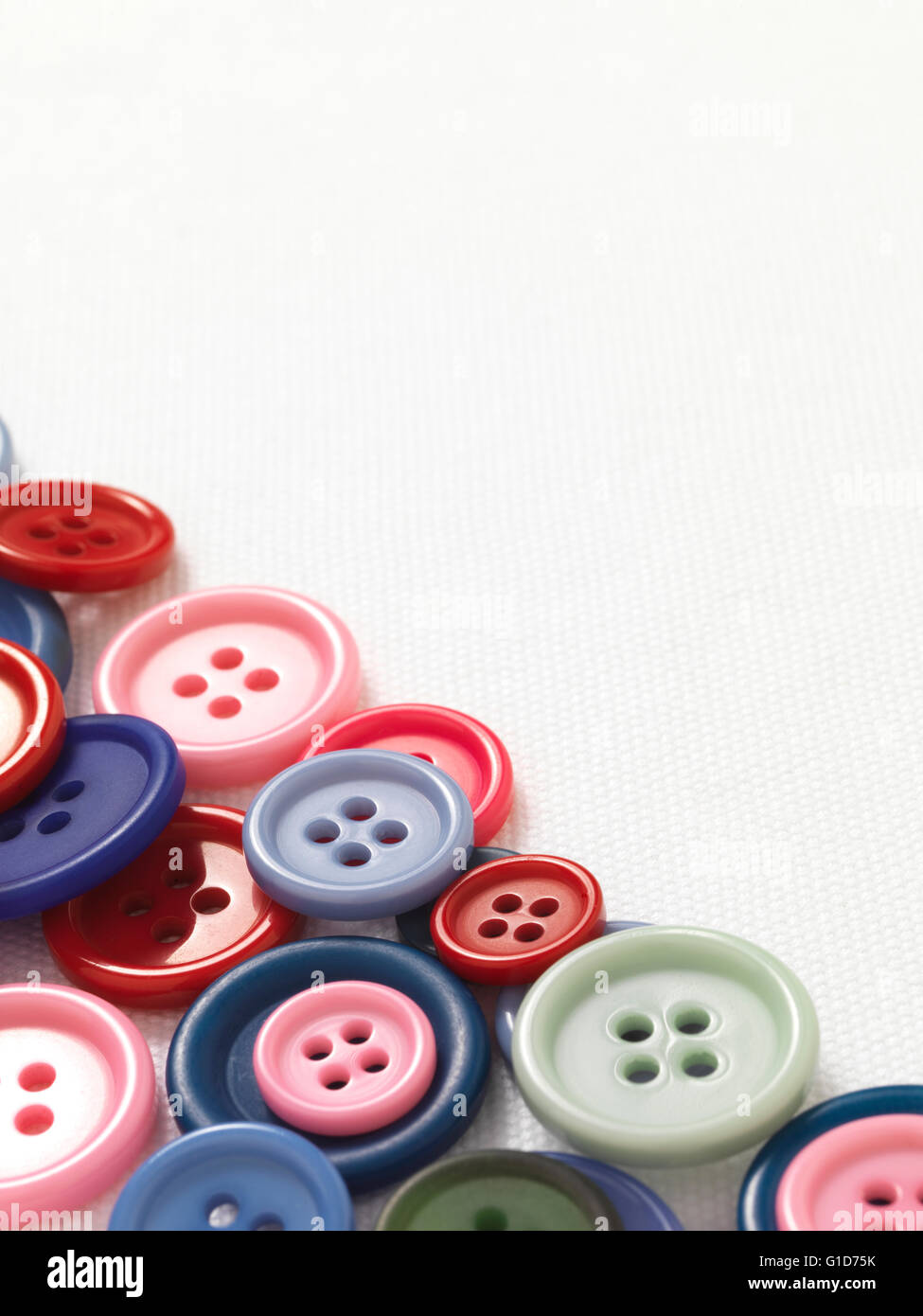 Buttons on white cotton background Stock Photo - Alamy