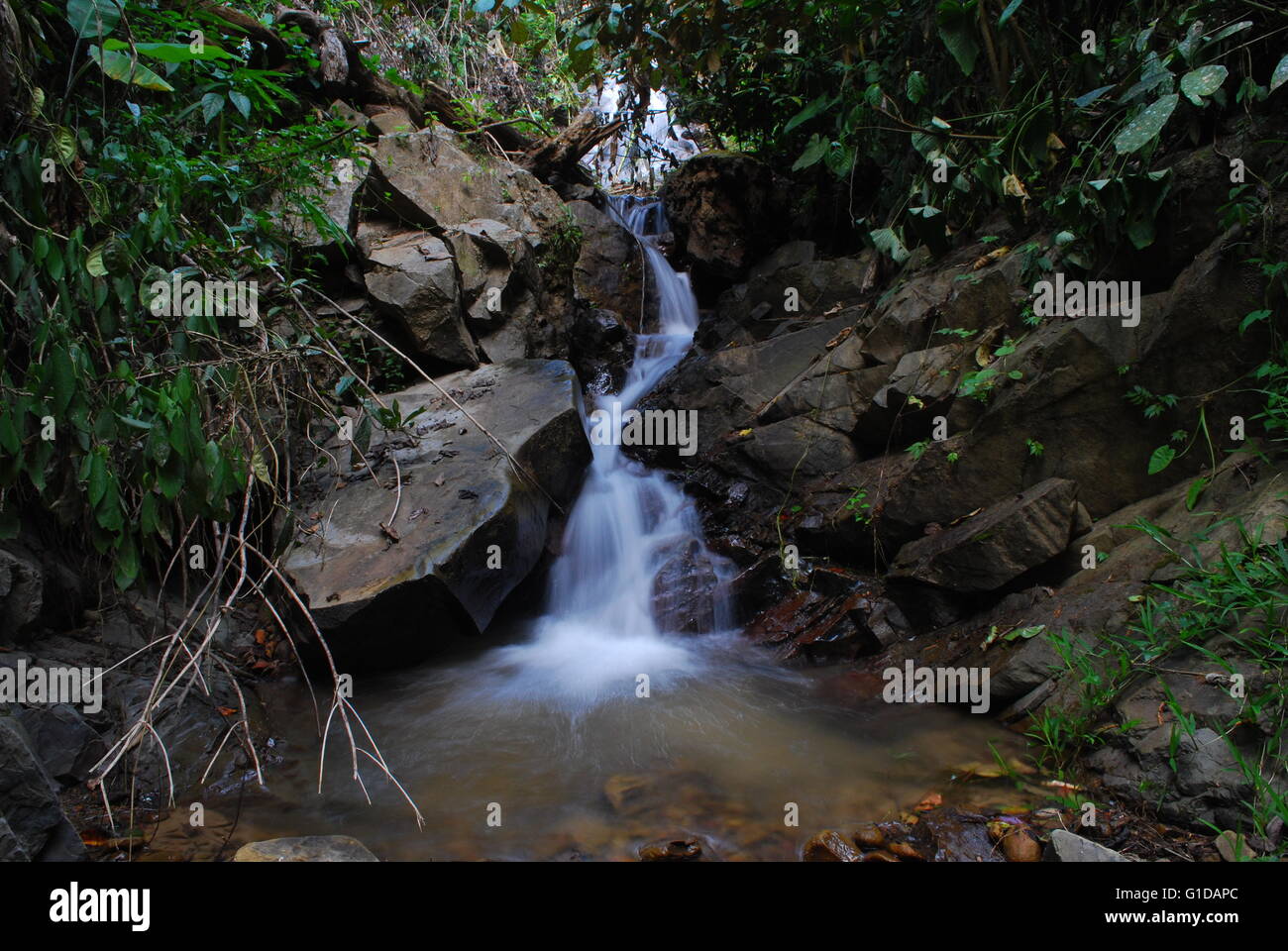 The cascading minor waterfall located in the forest of Sunsuron Village ...