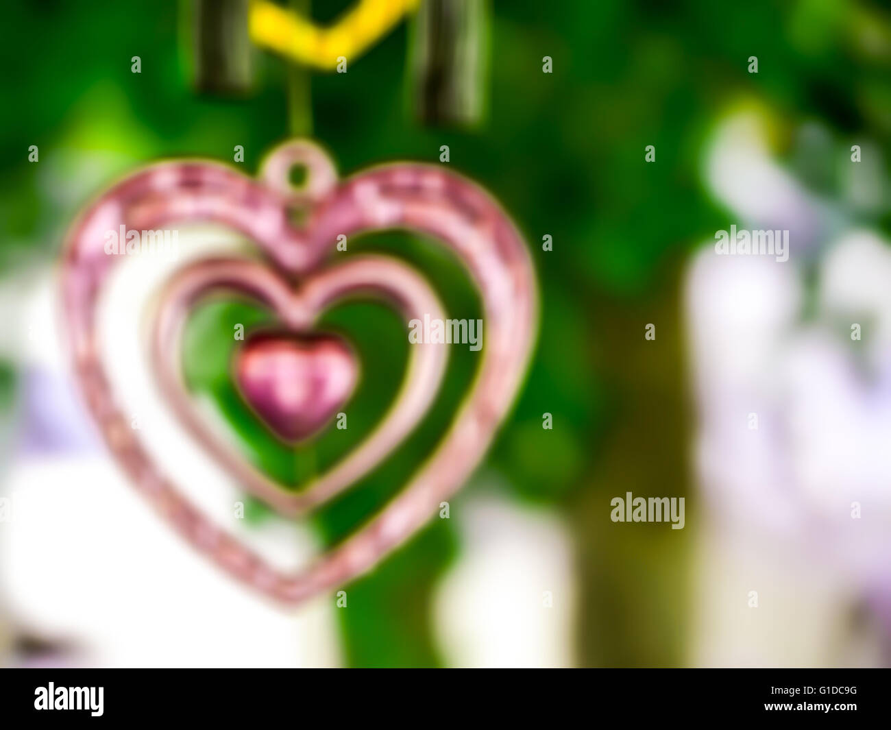 Heart a moblie decoration made of small objects tied to wires or string ...