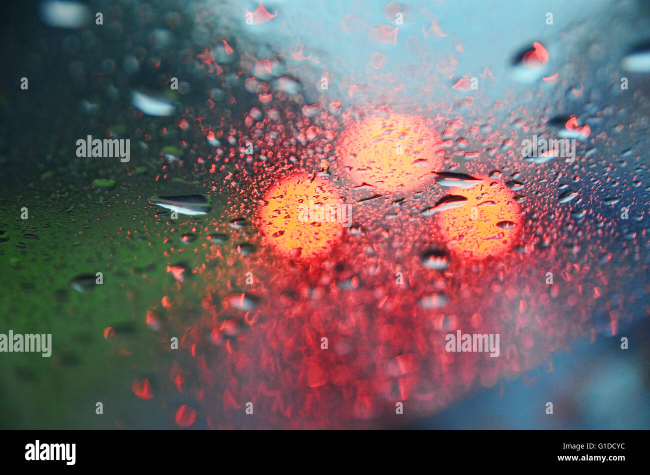 Bokeh of a red lights of rear car, looking through a wet window Stock ...