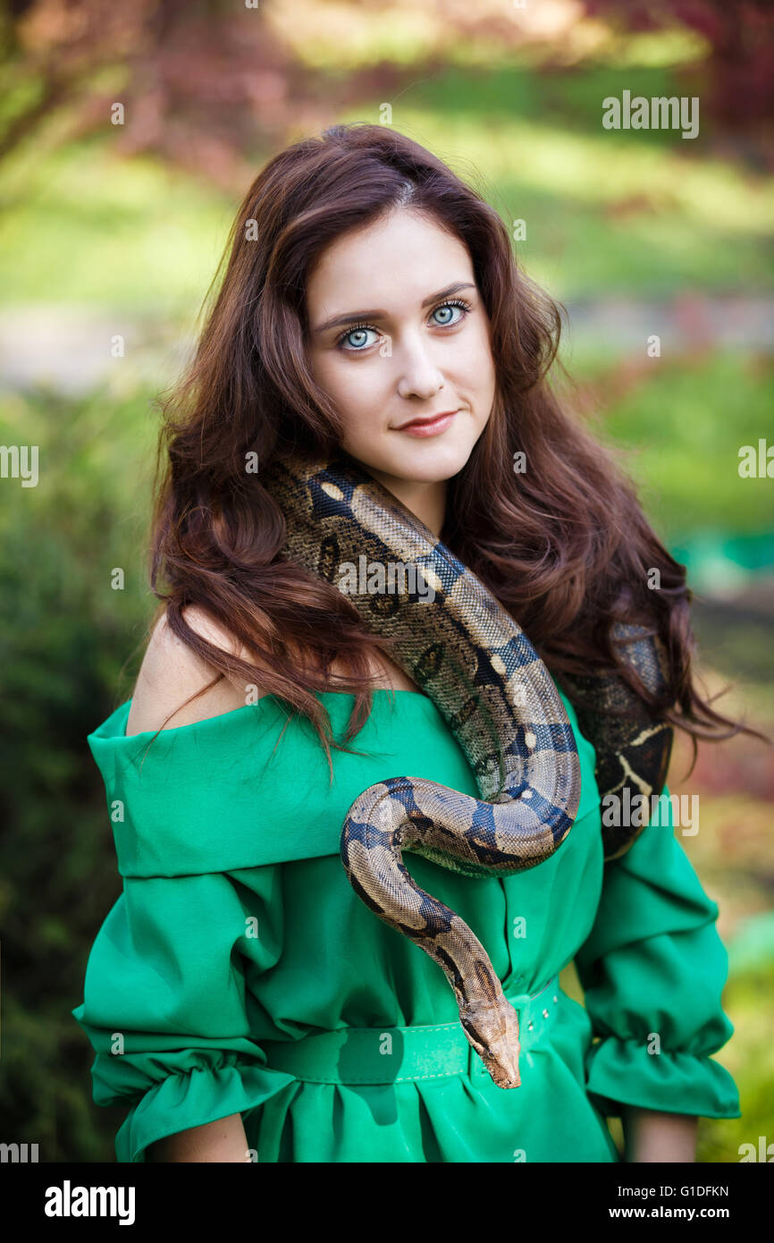 Portrait of the attractive teenage girl with snake in a garden Stock ...