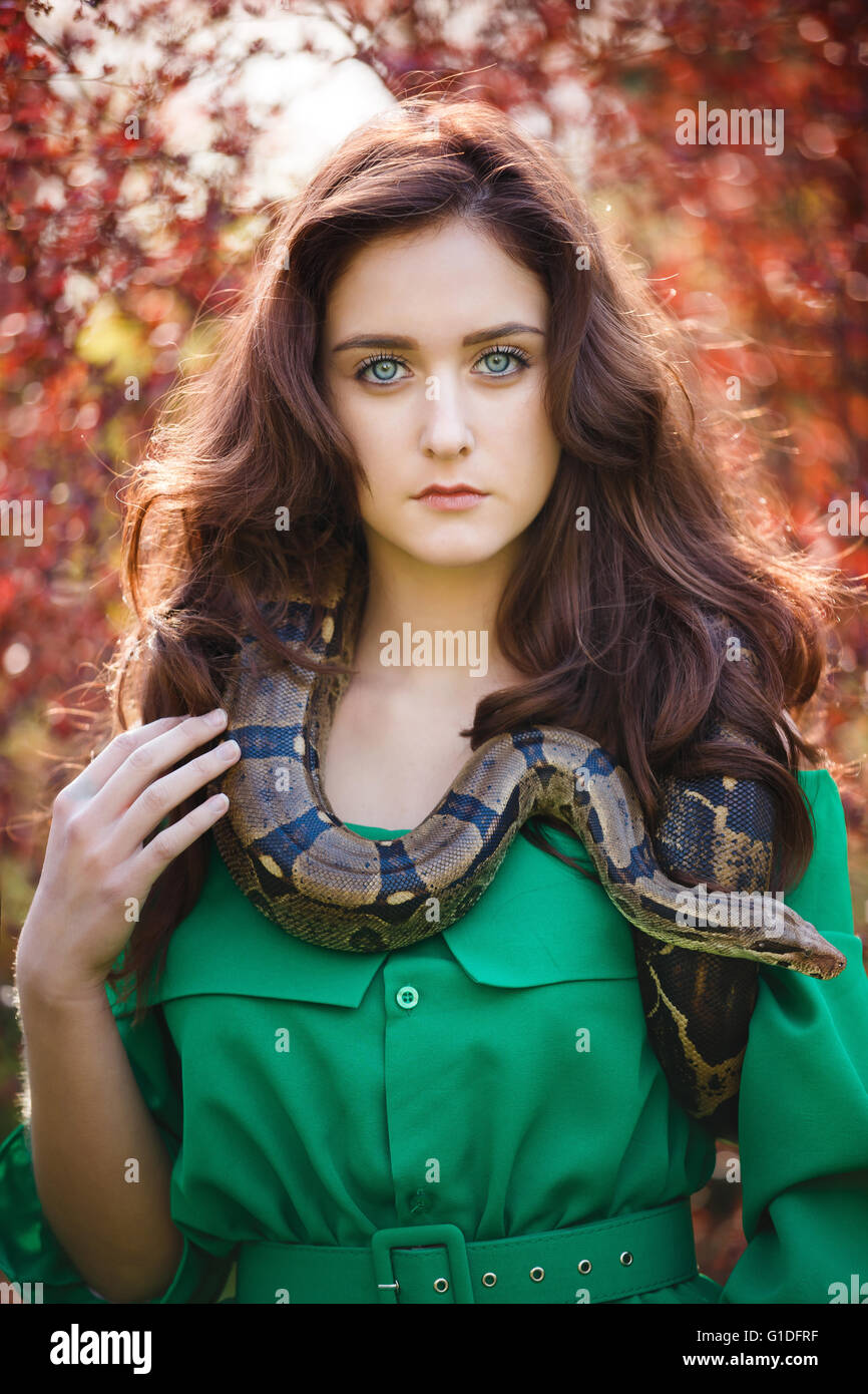 Portrait of the attractive teenage girl with snake in a garden Stock ...