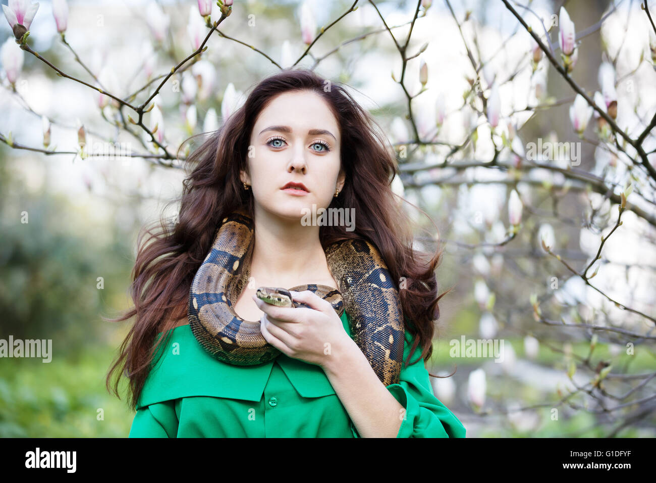 Portrait of the attractive teenage girl with snake in a garden Stock ...