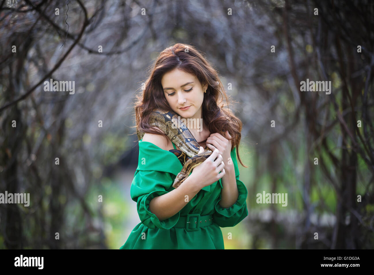 Portrait of the attractive teenage girl with snake in a garden Stock ...