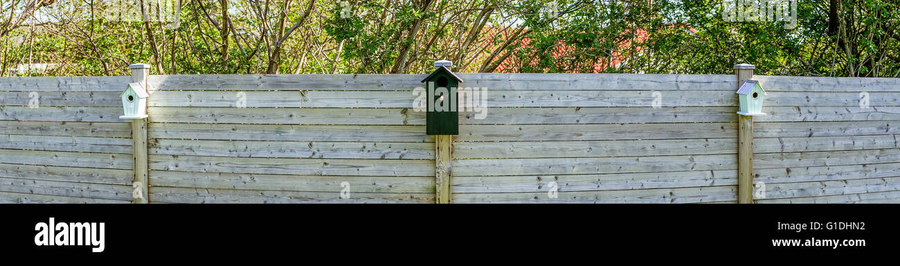 Bird houses on a row in a garden in panorama Stock Photo - Alamy