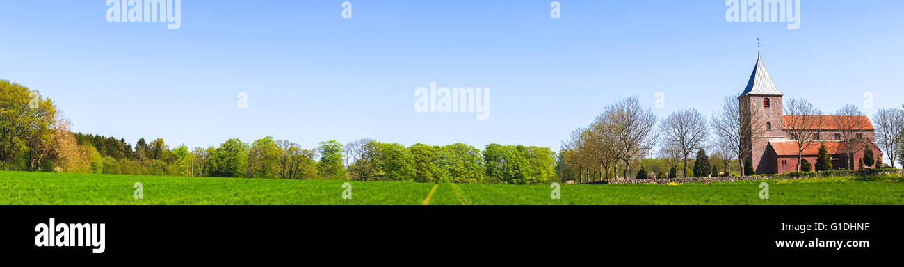 Panorama landscape with a church on a meadow Stock Photo - Alamy