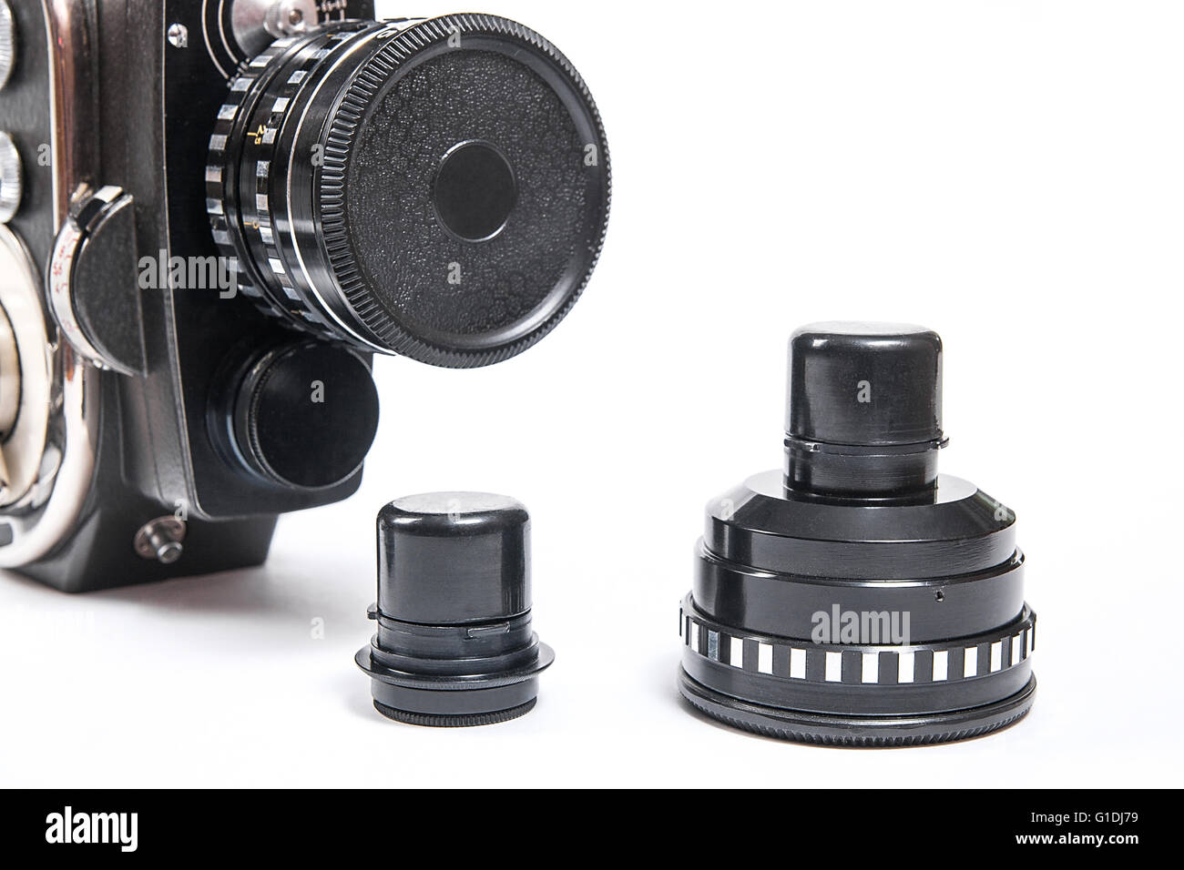 Old movie camera with two additional lens isolated on a white ...