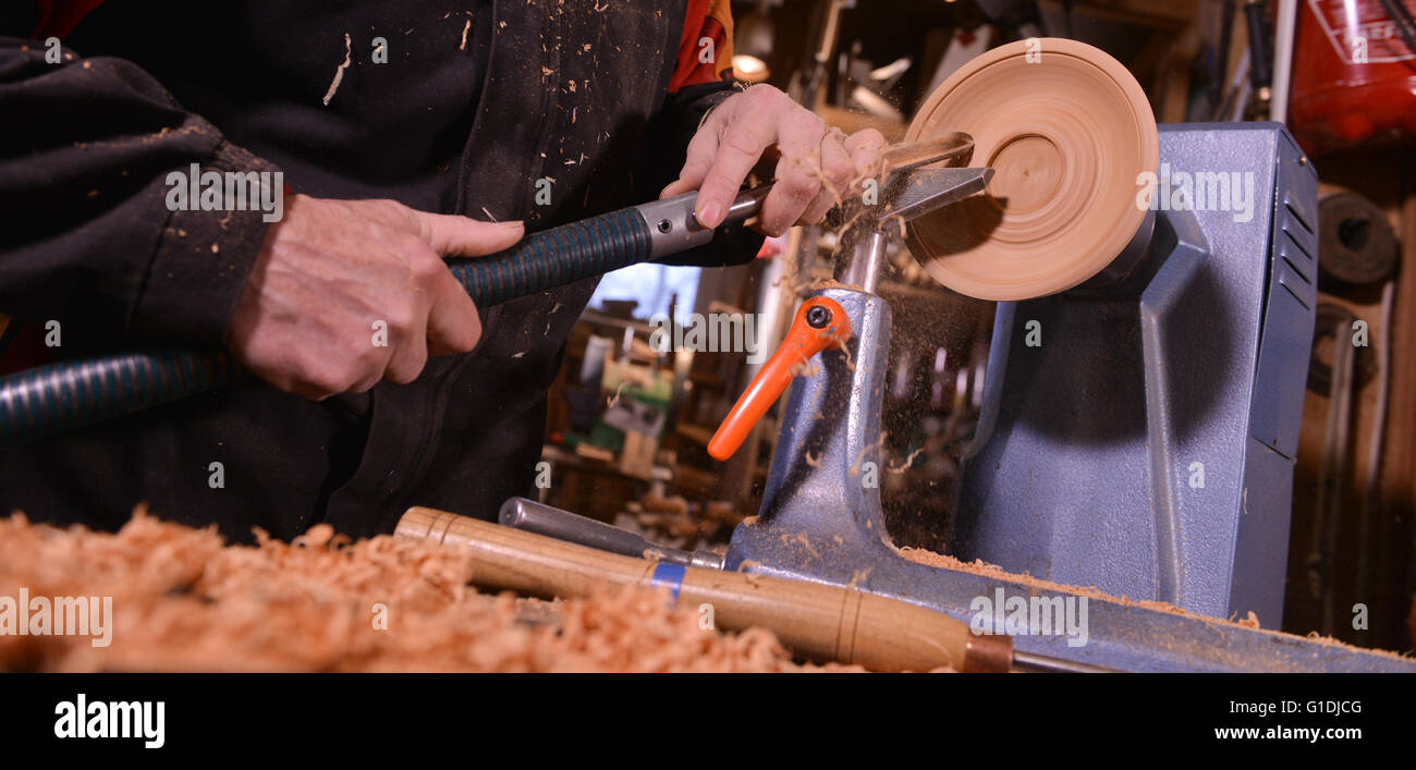 Woodturners using a rotating clamp to turn the wood, France Stock Photo ...