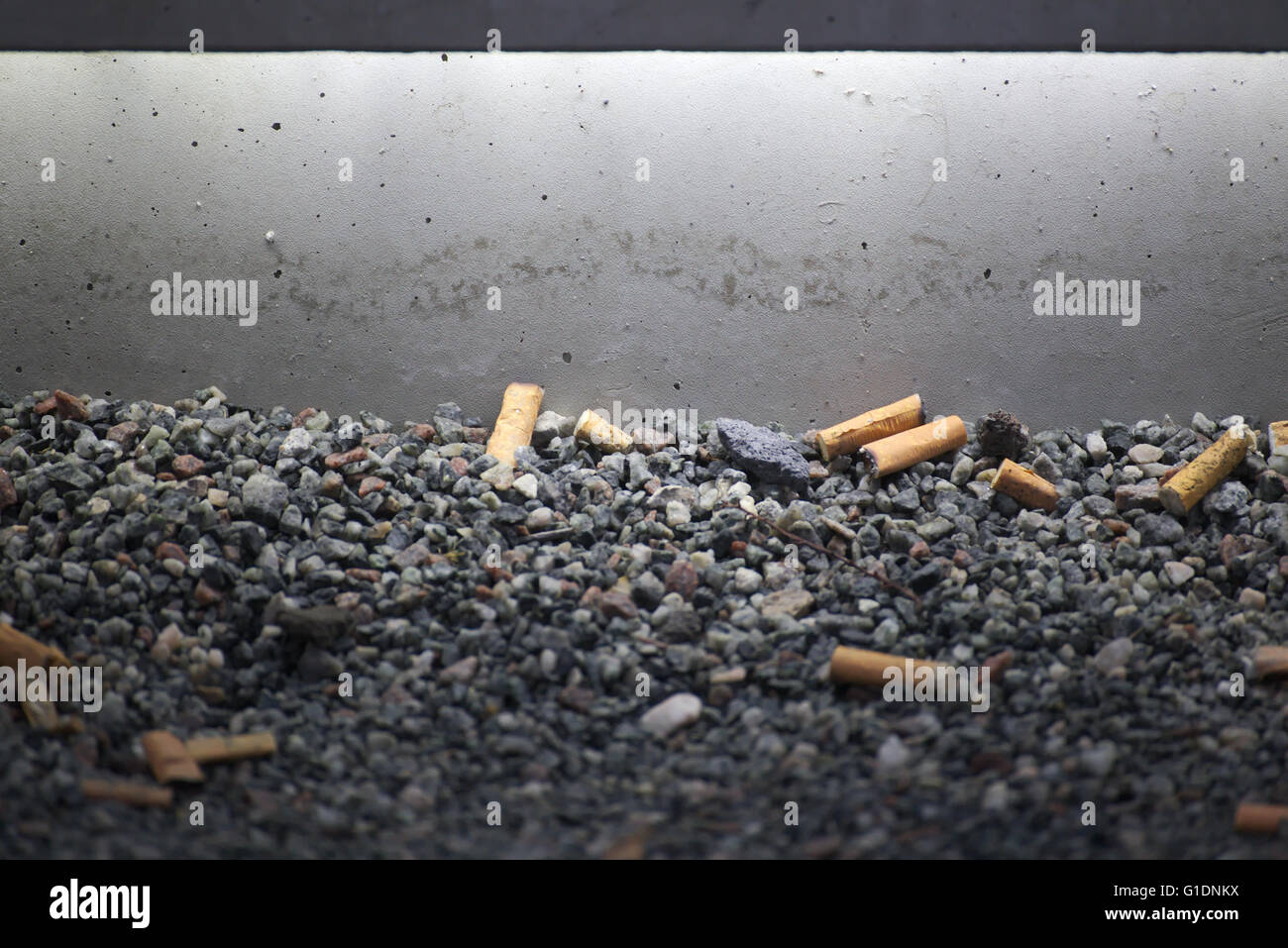 Cigarette stubs in a shot with unusual light Stock Photo - Alamy