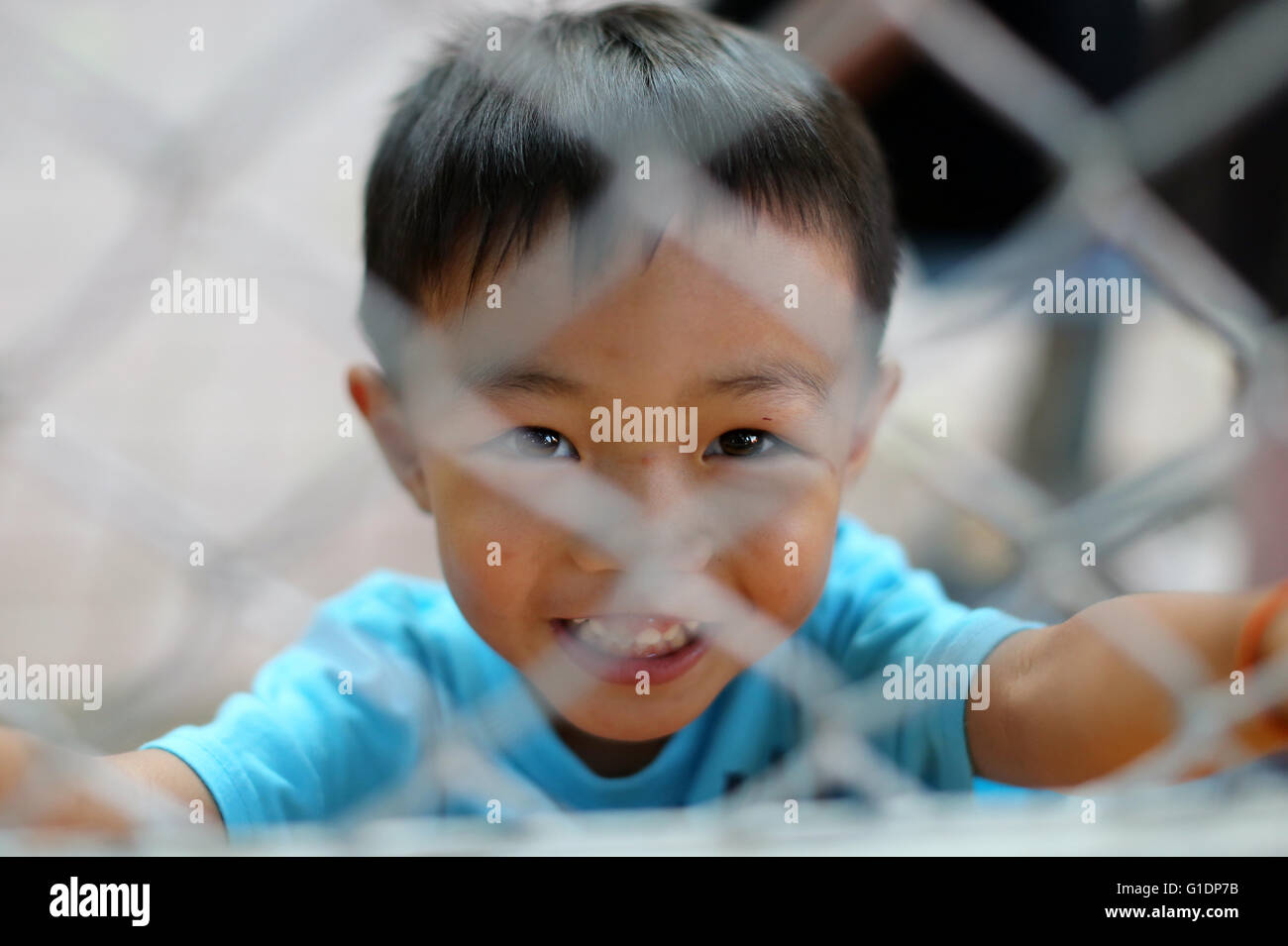 Boy behind the fence hi-res stock photography and images - Alamy