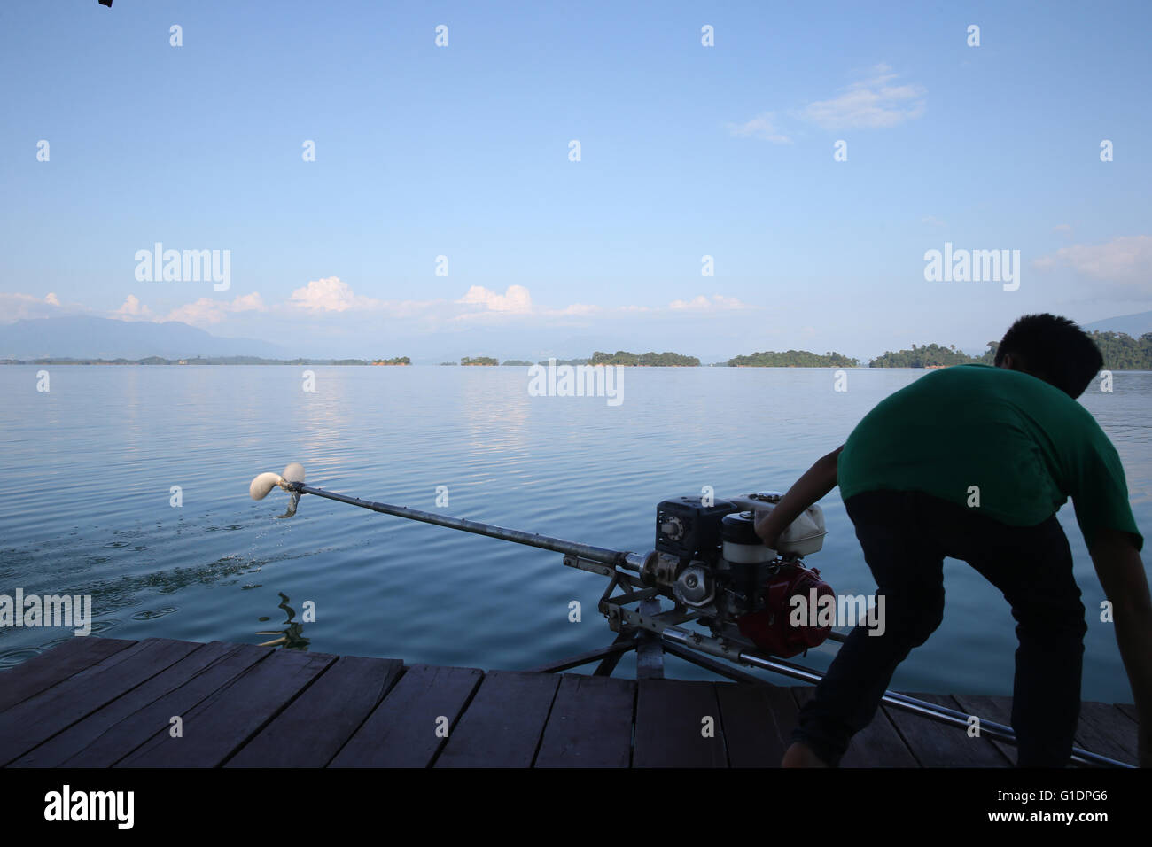 Nam Ngum lake. Boy steering a traditional Lao motor boat. Laos Stock ...