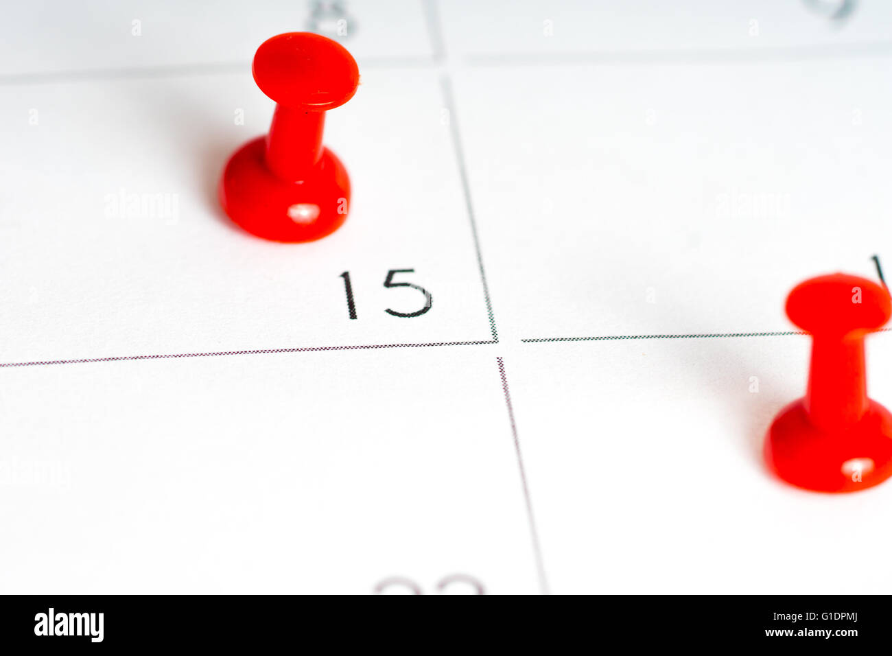 two red pins on calendar grid Stock Photo - Alamy