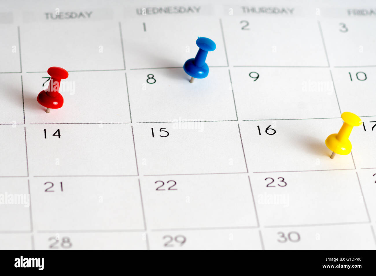 red blue yellow pins on calendar grid Stock Photo - Alamy