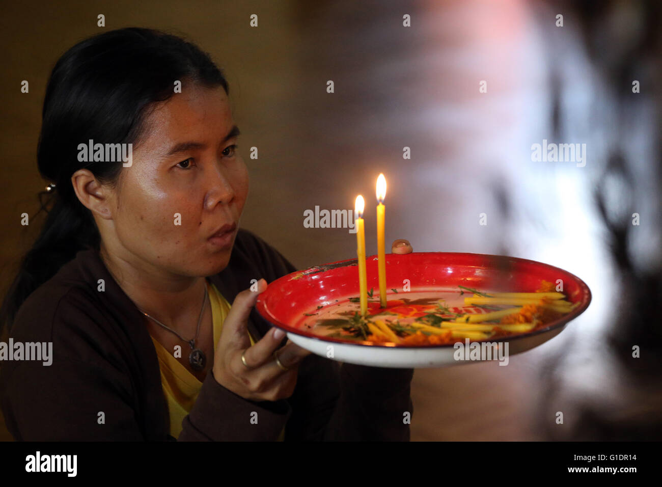 Wat Si Muang ( Simuong) buddhist temple. Buddhist ceremony. Worshiper ...