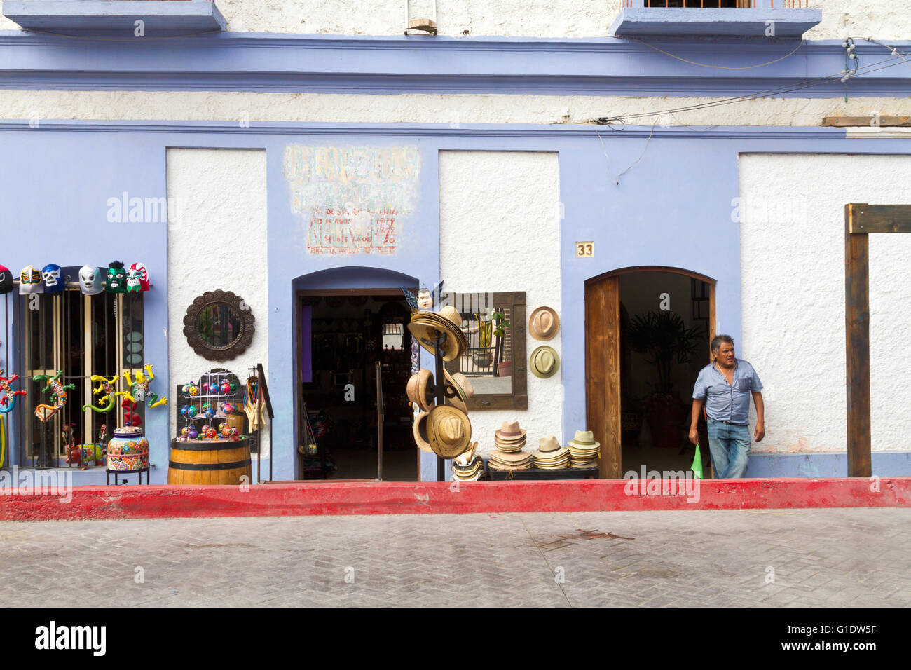 A Mexican shop owner stands in the doorway of his souvenir shop in ...