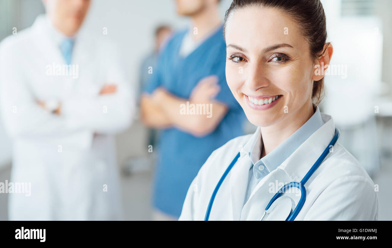 Professional female doctor smiling at camera and posing, medical staff ...