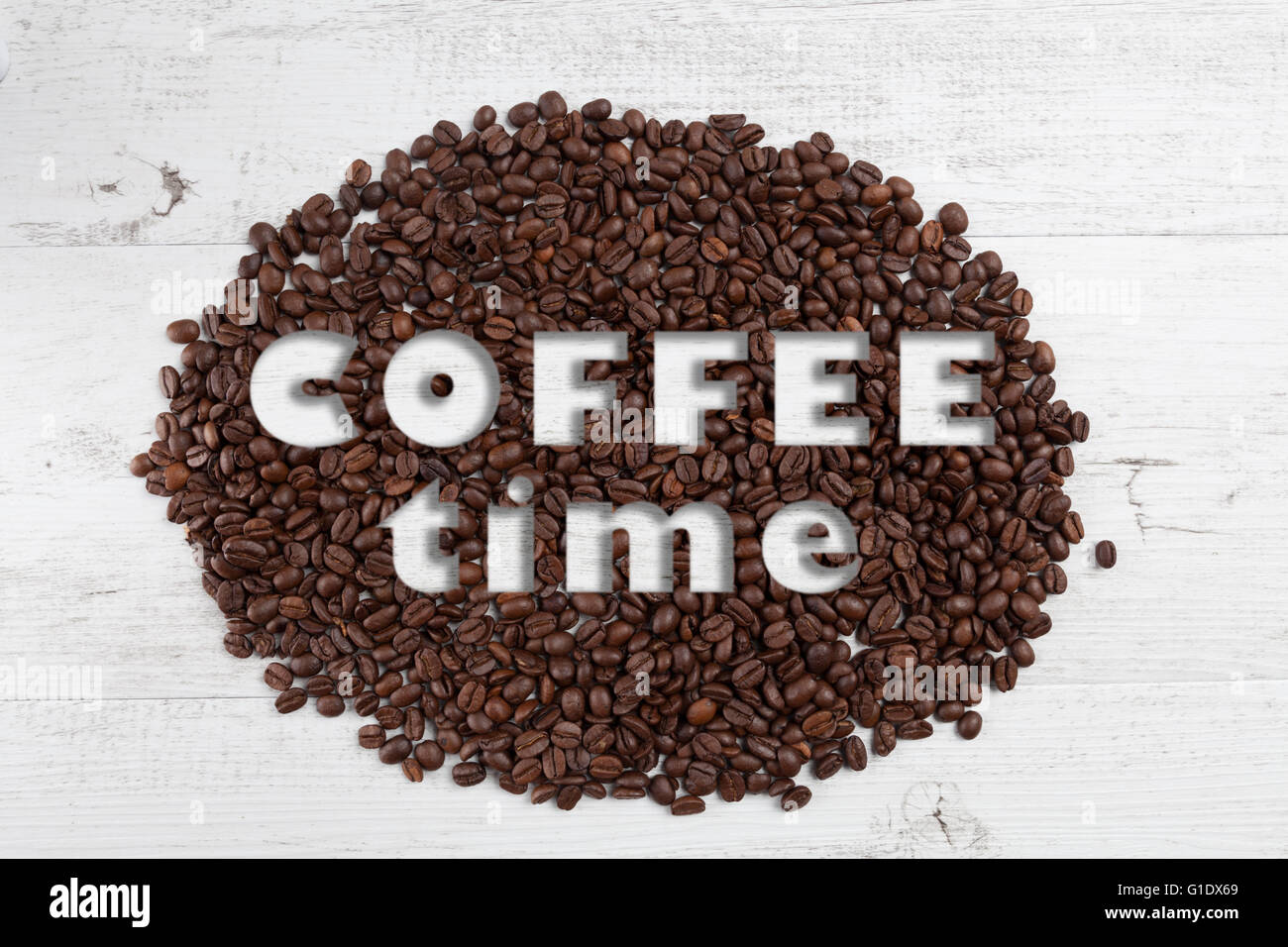 Coffee time text on scattered roasted coffee beans on white rustic ...
