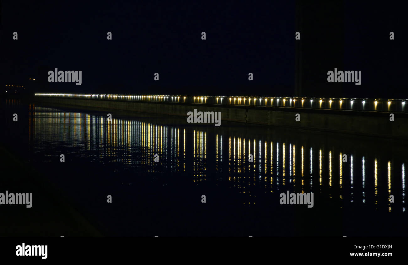 Long row of lights reflected on a river Stock Photo - Alamy