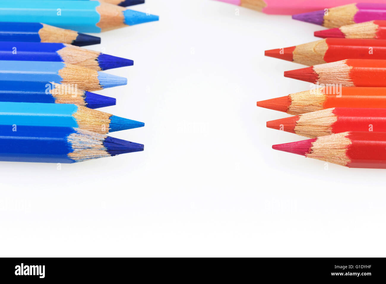 Crayons of different shades of red and blue color with copy space are ...