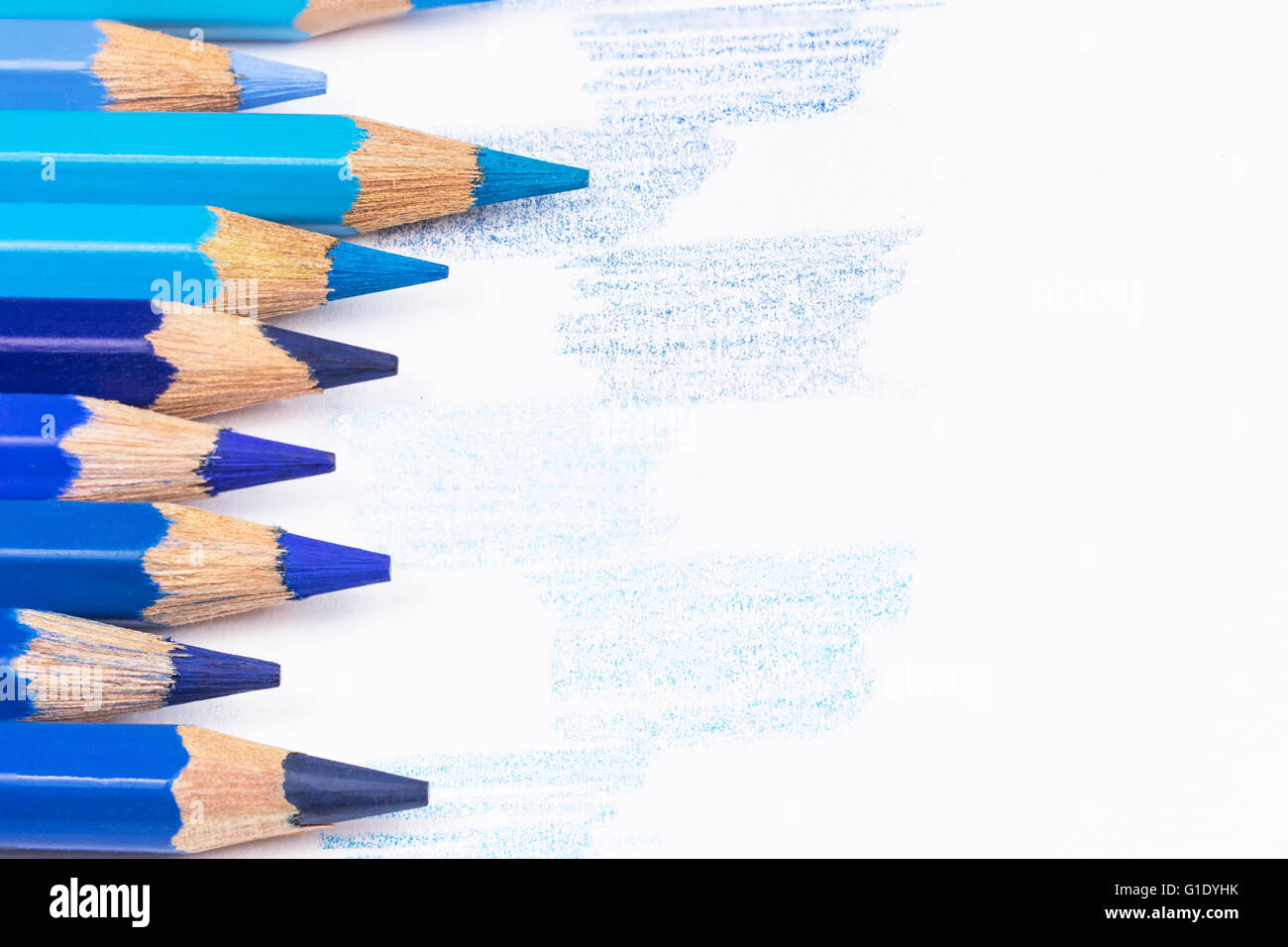 Crayons of different shades of blue color are located on the left side ...