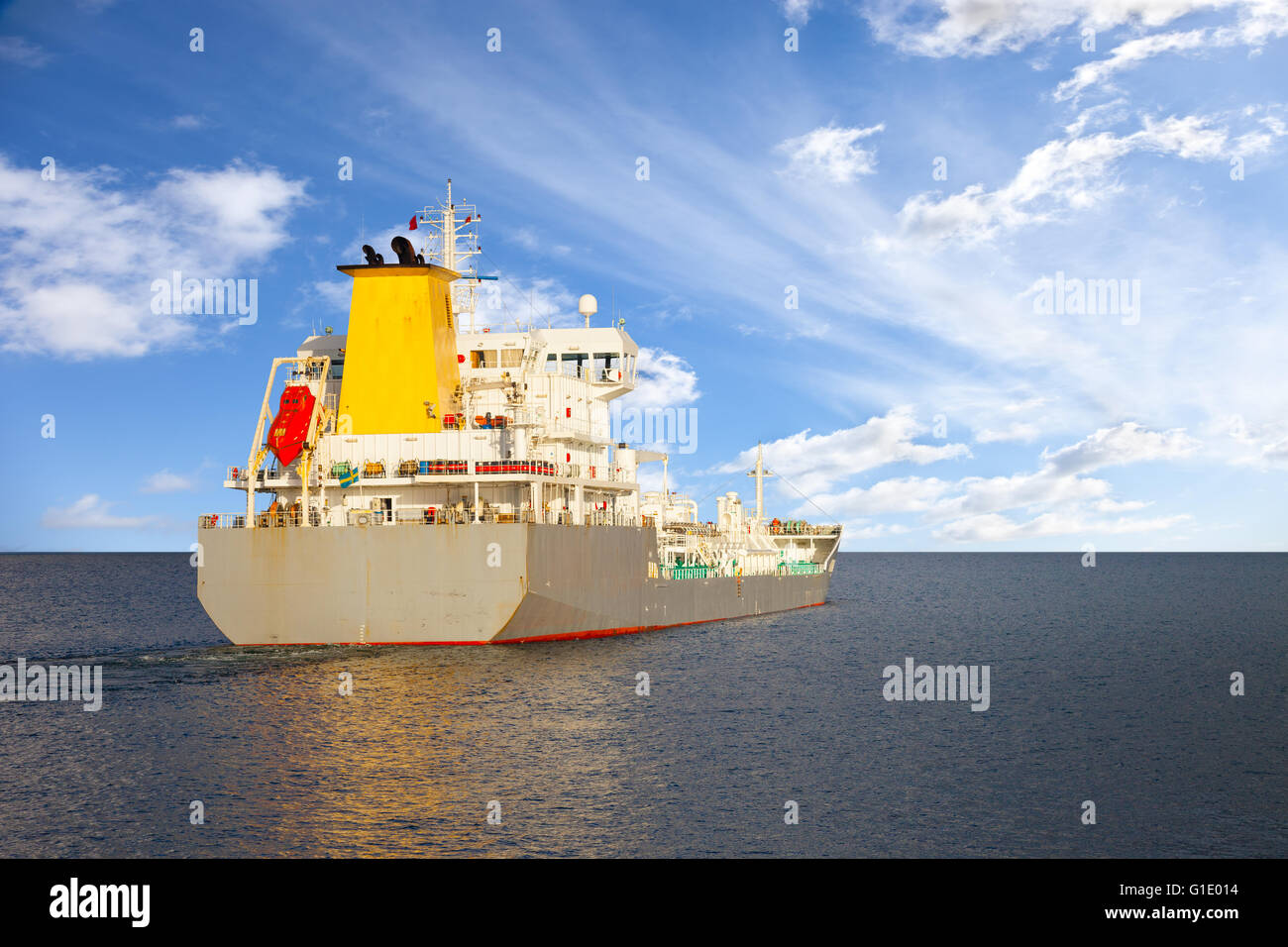 Oil tanker ship at sea on a background of blue sky Stock Photo - Alamy
