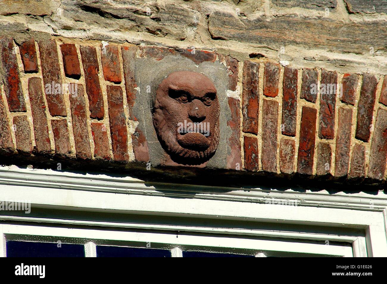 New York City Grim red sandstone face above a ground floor window at ...