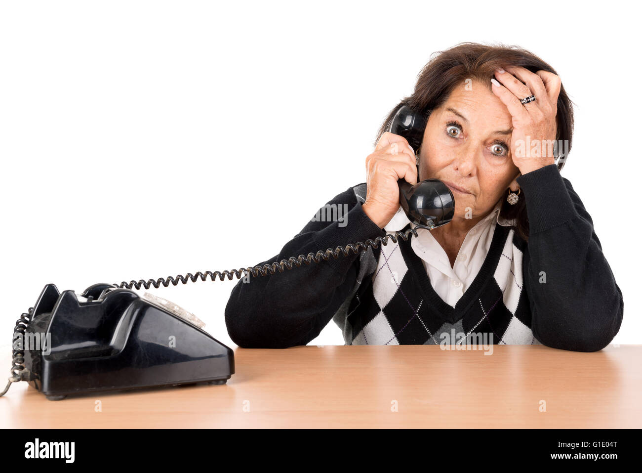 Desperate senior woman with telephone isolated in white Stock Photo - Alamy