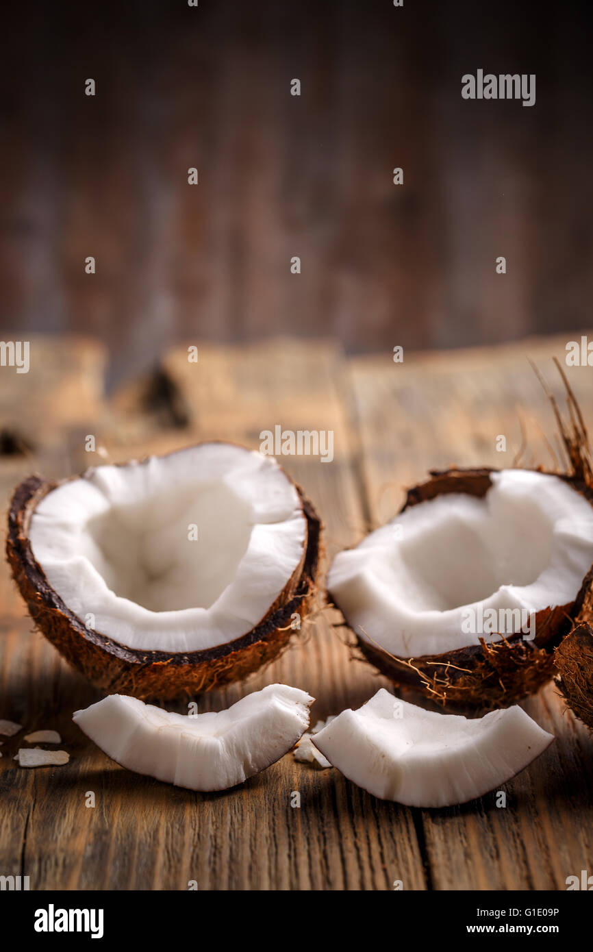 Coconut pieces on vintage wooden background Stock Photo - Alamy