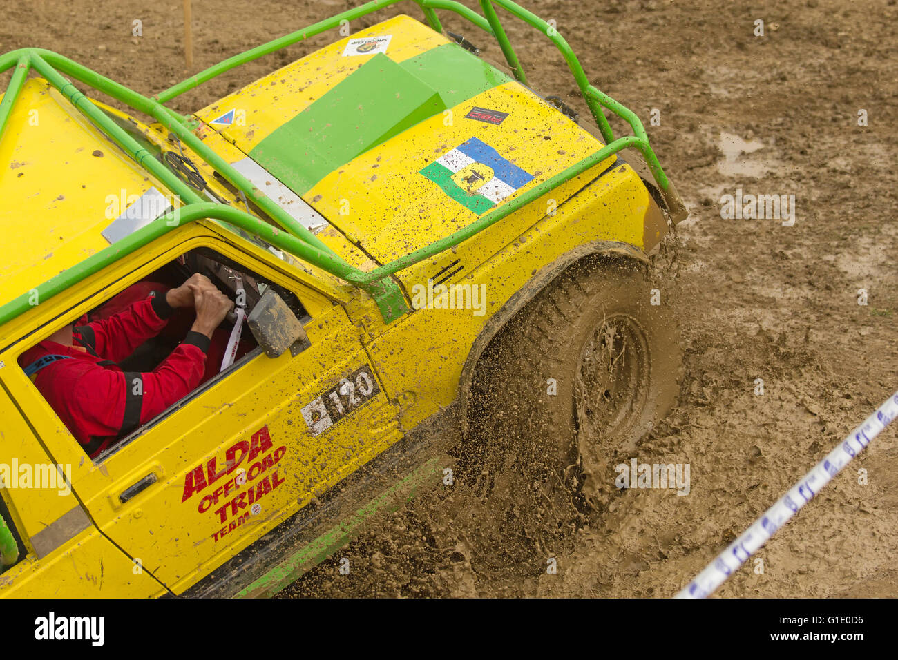 Unidentified racer at yellow off-road car leaves muddy puddle Stock ...
