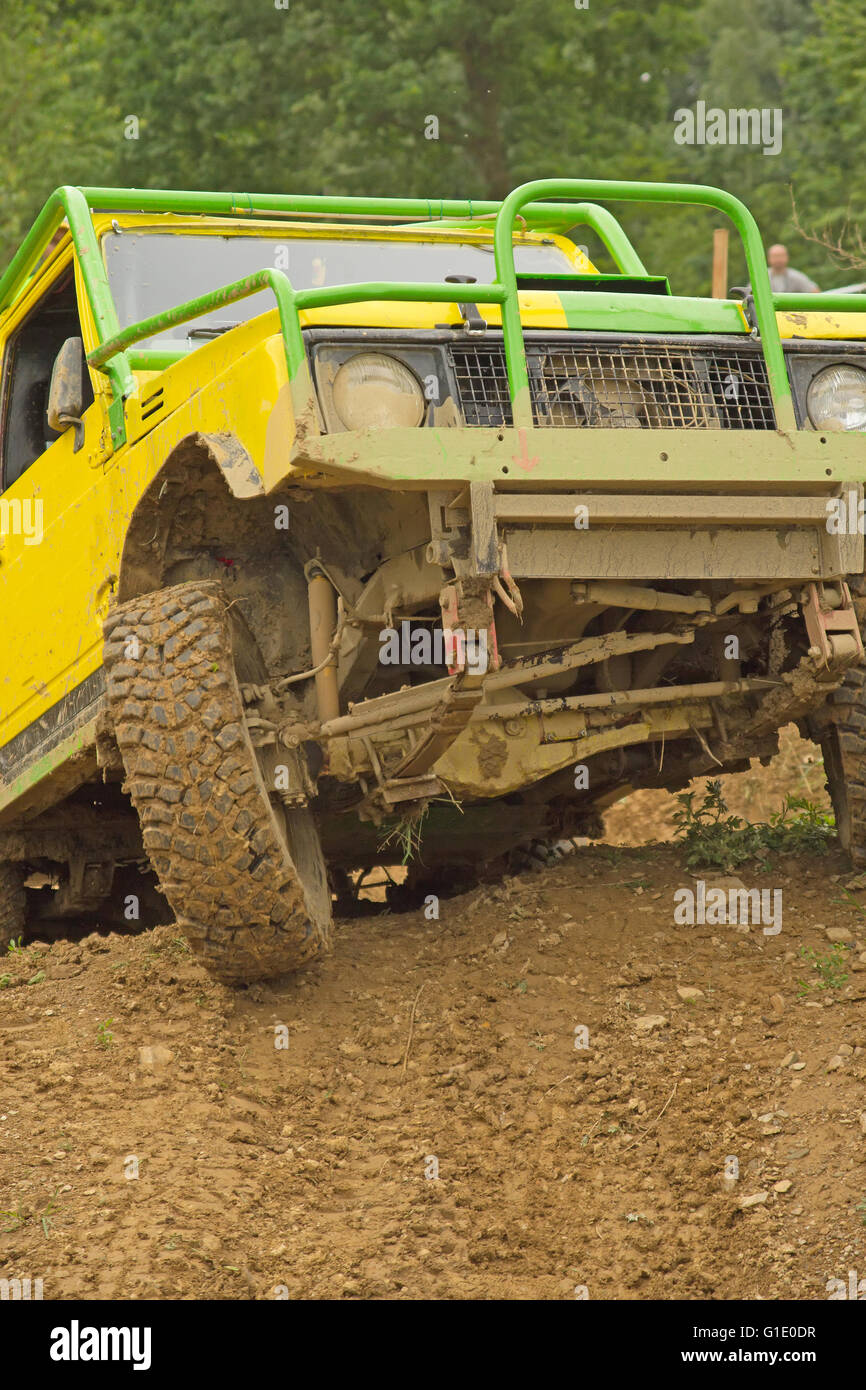 Yellow off-road car leaves steep slope. All potential trademarks are ...