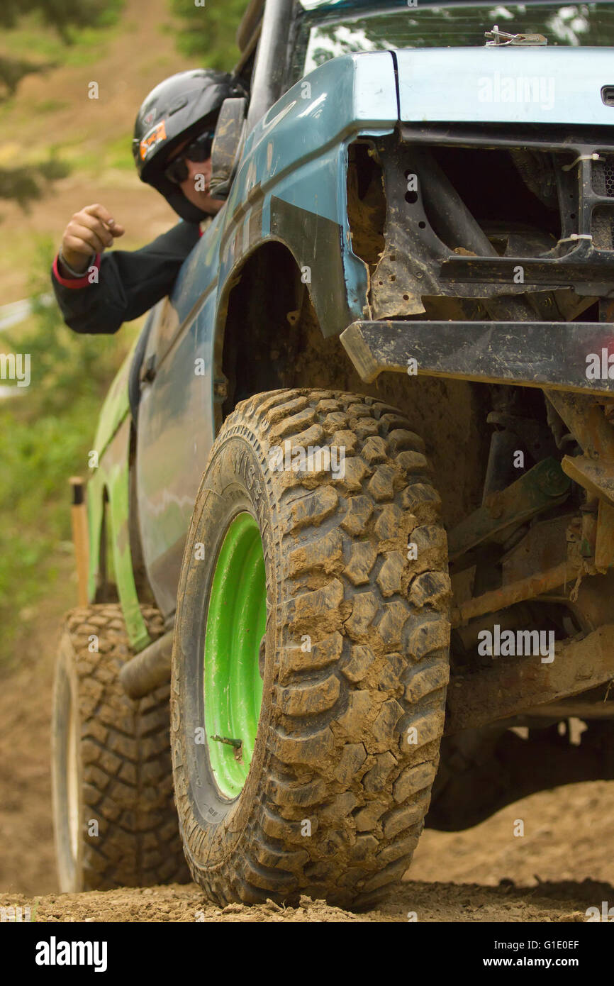 Unidentified passenger at off-road car on a steep slope in the race ...
