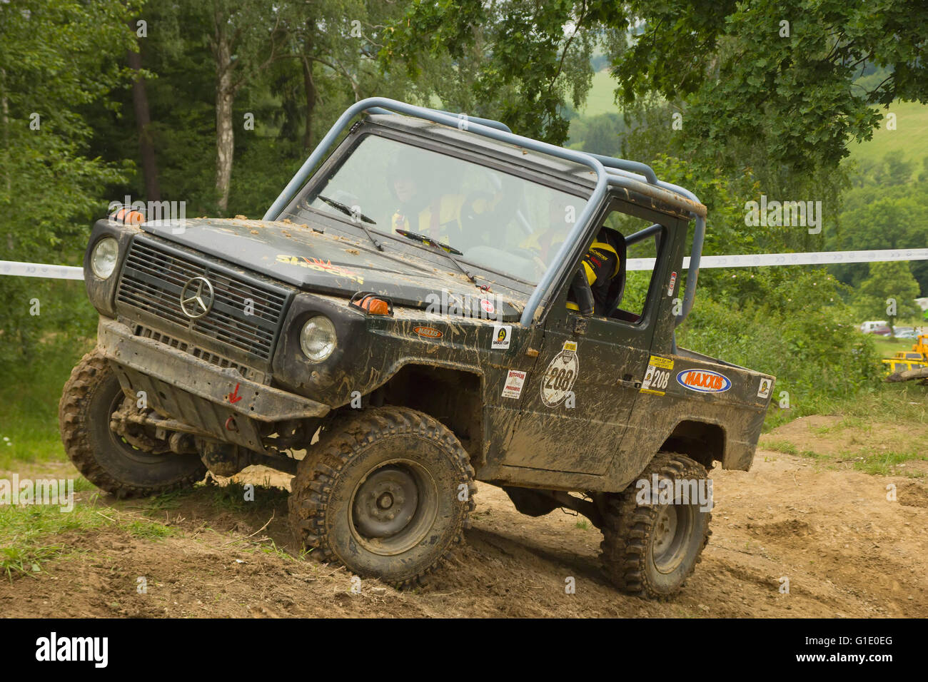 Unidentified racer at blue off-road car Mercedes on a steep slope Stock ...