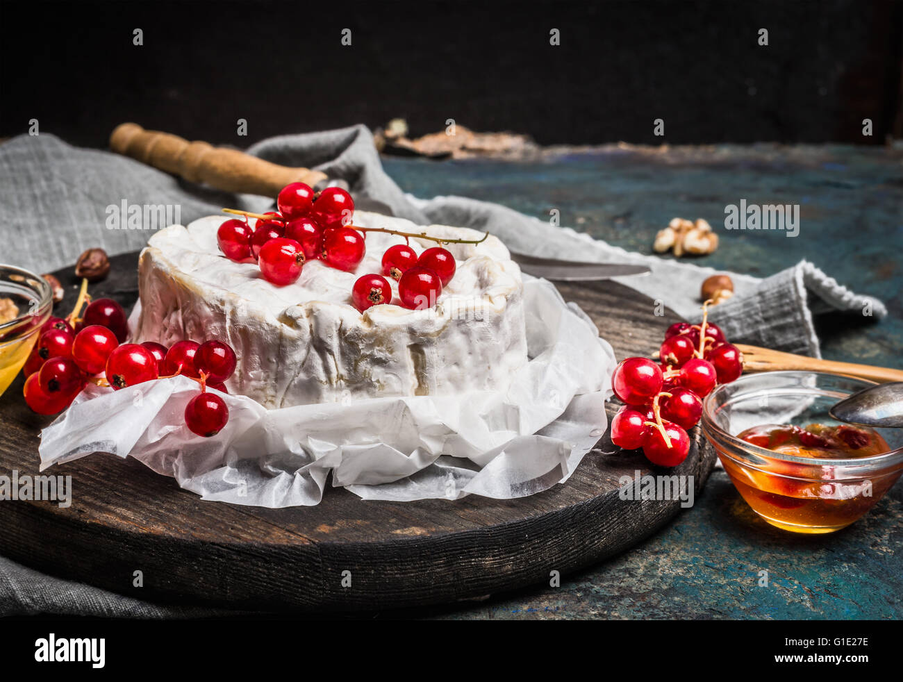 Camembert cheese plate with red berries, side view Stock Photo - Alamy