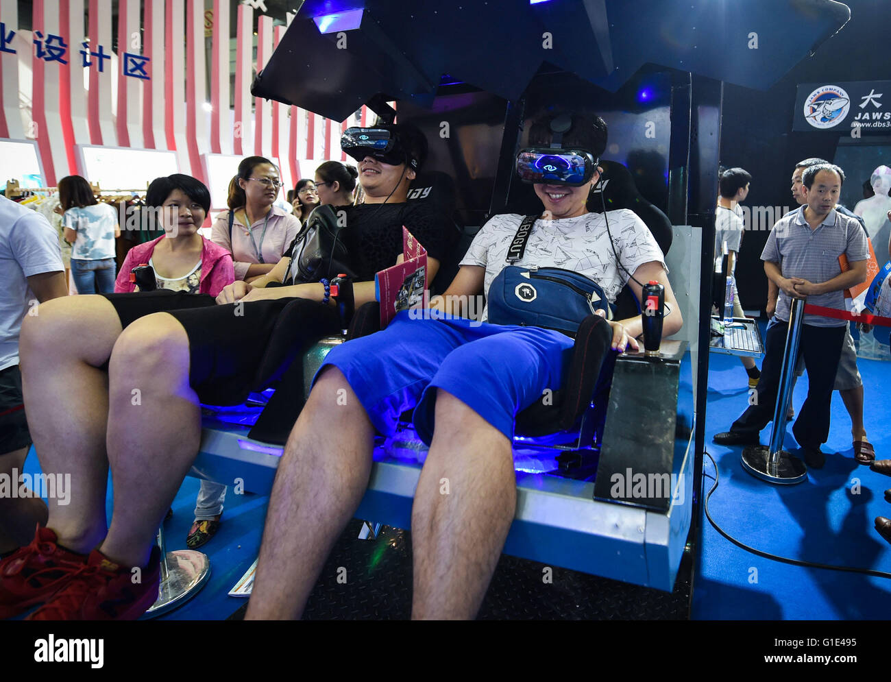 Shenzhen, China's Guangdong Province. 13th May, 2016. Visitors try the ...