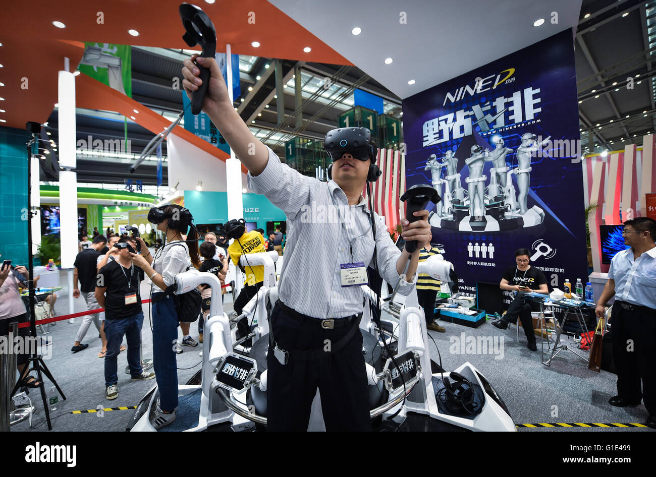 Shenzhen, China's Guangdong Province. 13th May, 2016. A visitor plays a ...