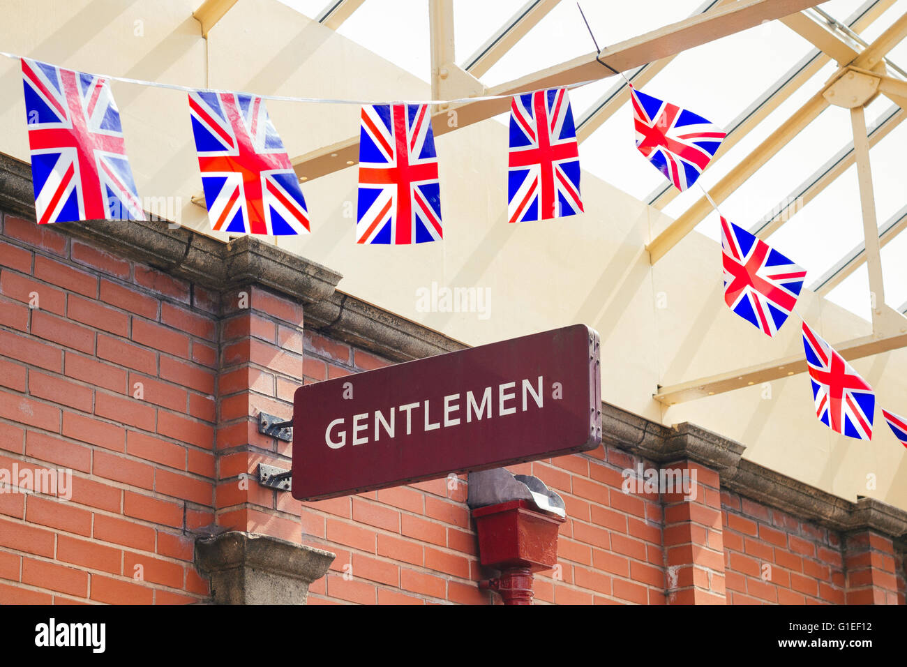 Vintage gentlemen sign with Union Jack bunting and brick wall in the ...
