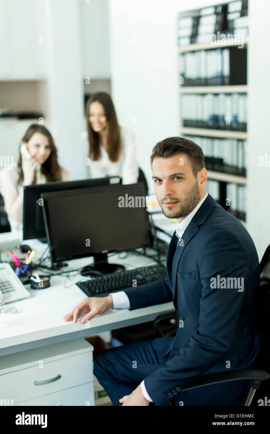 View of the man sitting at the desk in the office Stock Photo - Alamy