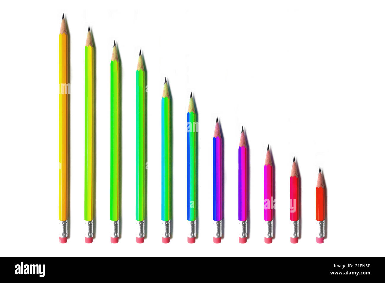 A line of colourful pencils photographed against a white background ...