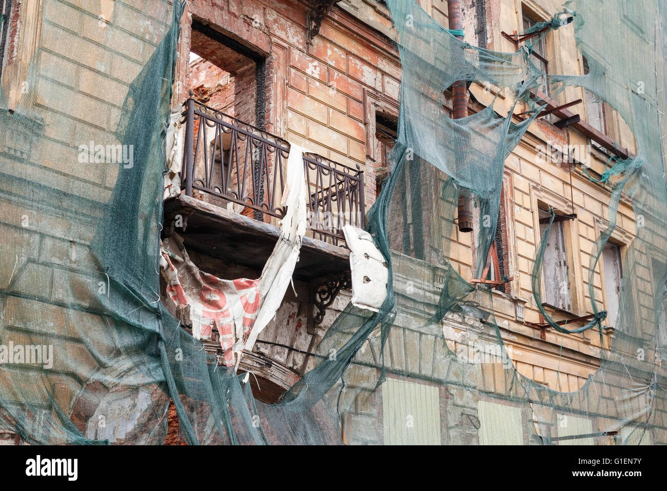 Old living house is under reconstruction, facade with broken balcony is ...