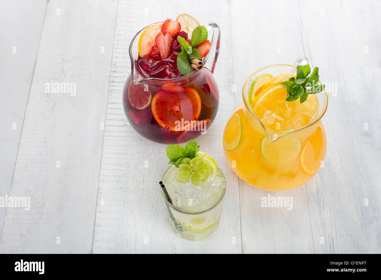 Three summer lemonade on a white wooden background Stock Photo - Alamy