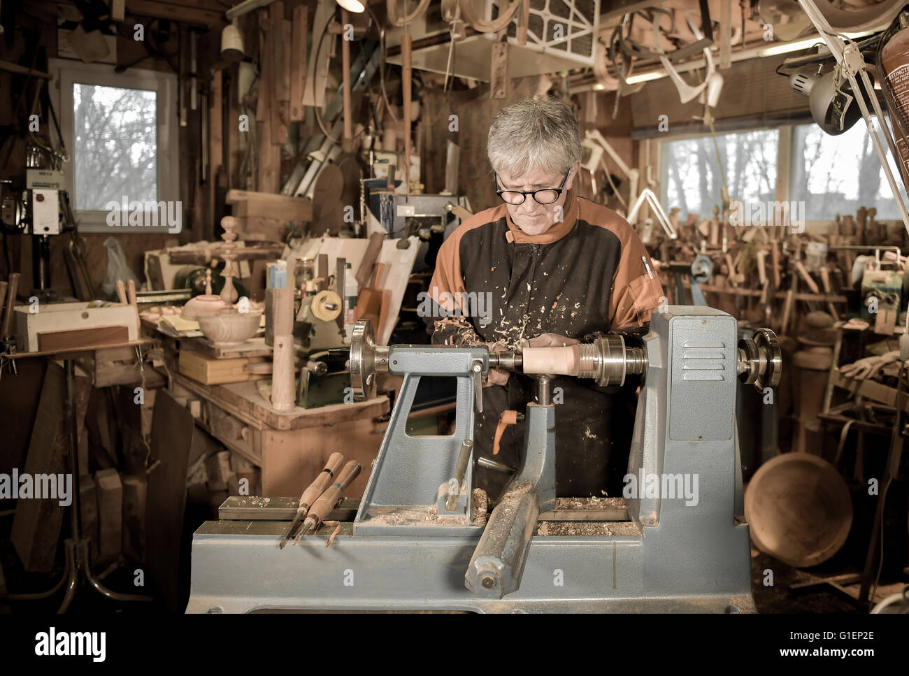 Wood turners using a rotating clamp to turn the wood, France Stock ...