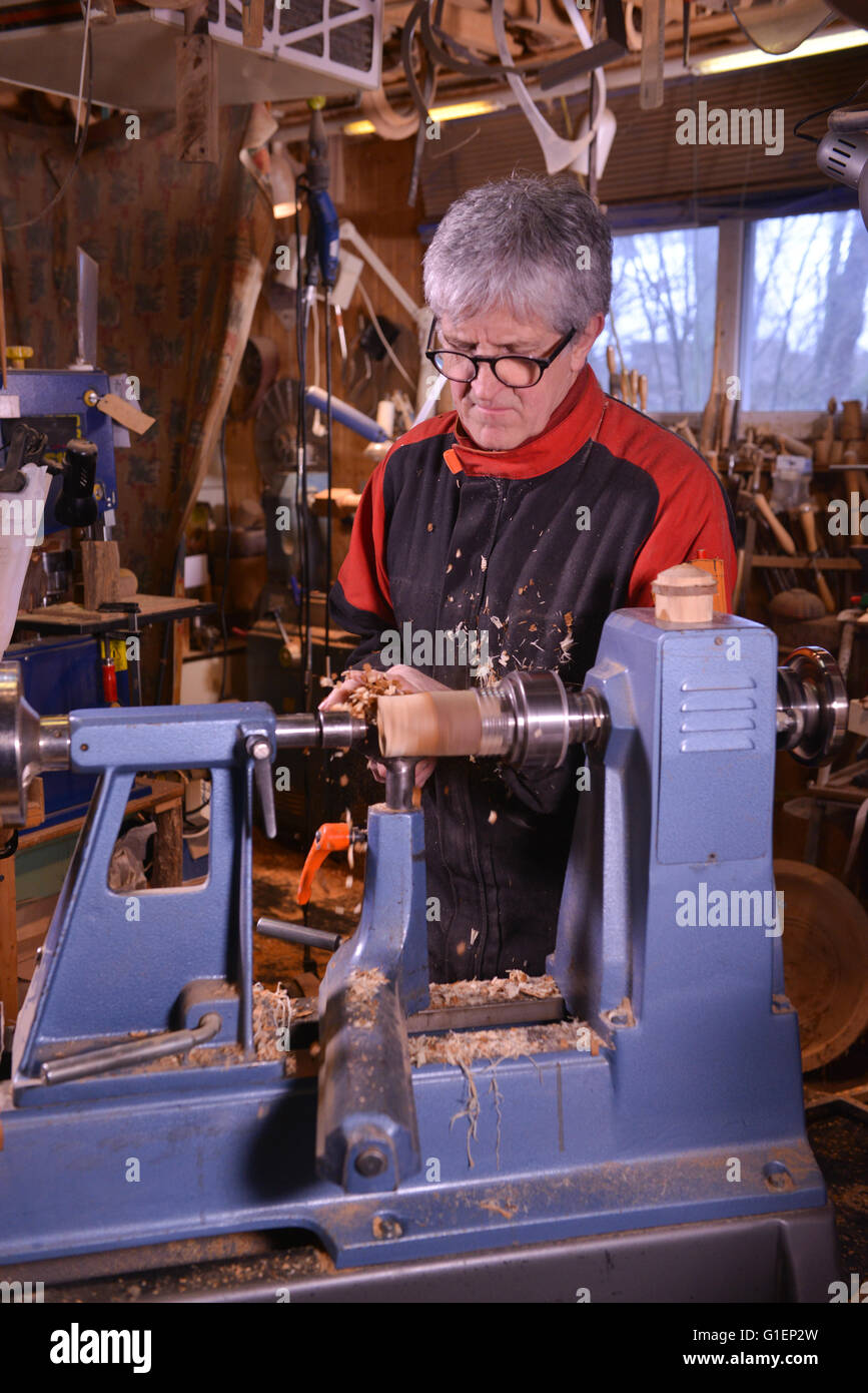 Wood turners using a rotating clamp to turn the wood, France Stock ...