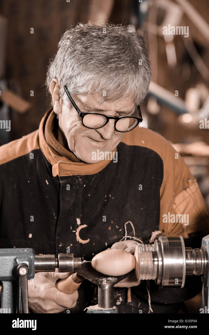 Wood turners using a rotating clamp to turn the wood, France Stock ...