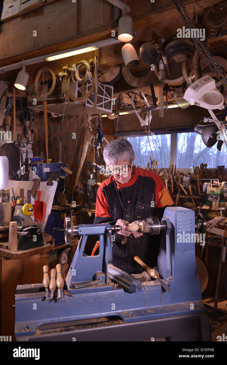 Wood turners using a rotating clamp to turn the wood, France Stock ...