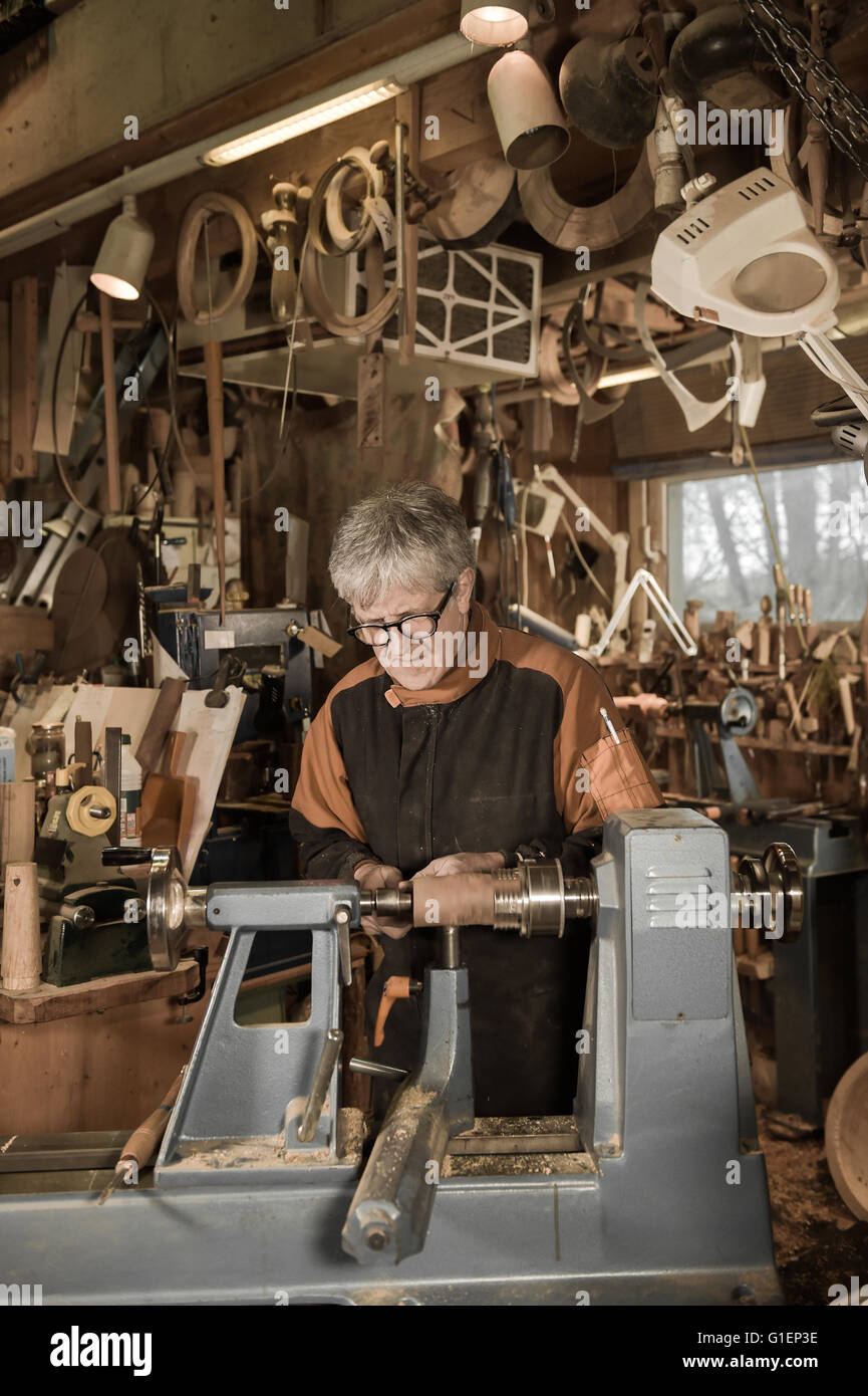 Wood turners using a rotating clamp to turn the wood, France Stock ...