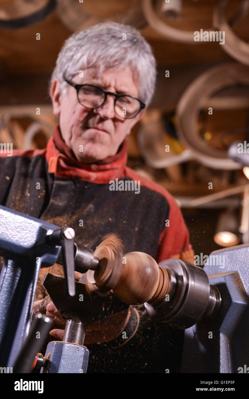 Wood turners using a rotating clamp to turn the wood, France Stock ...