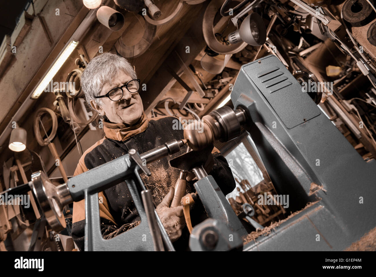 Wood turners using a rotating clamp to turn the wood, France Stock ...