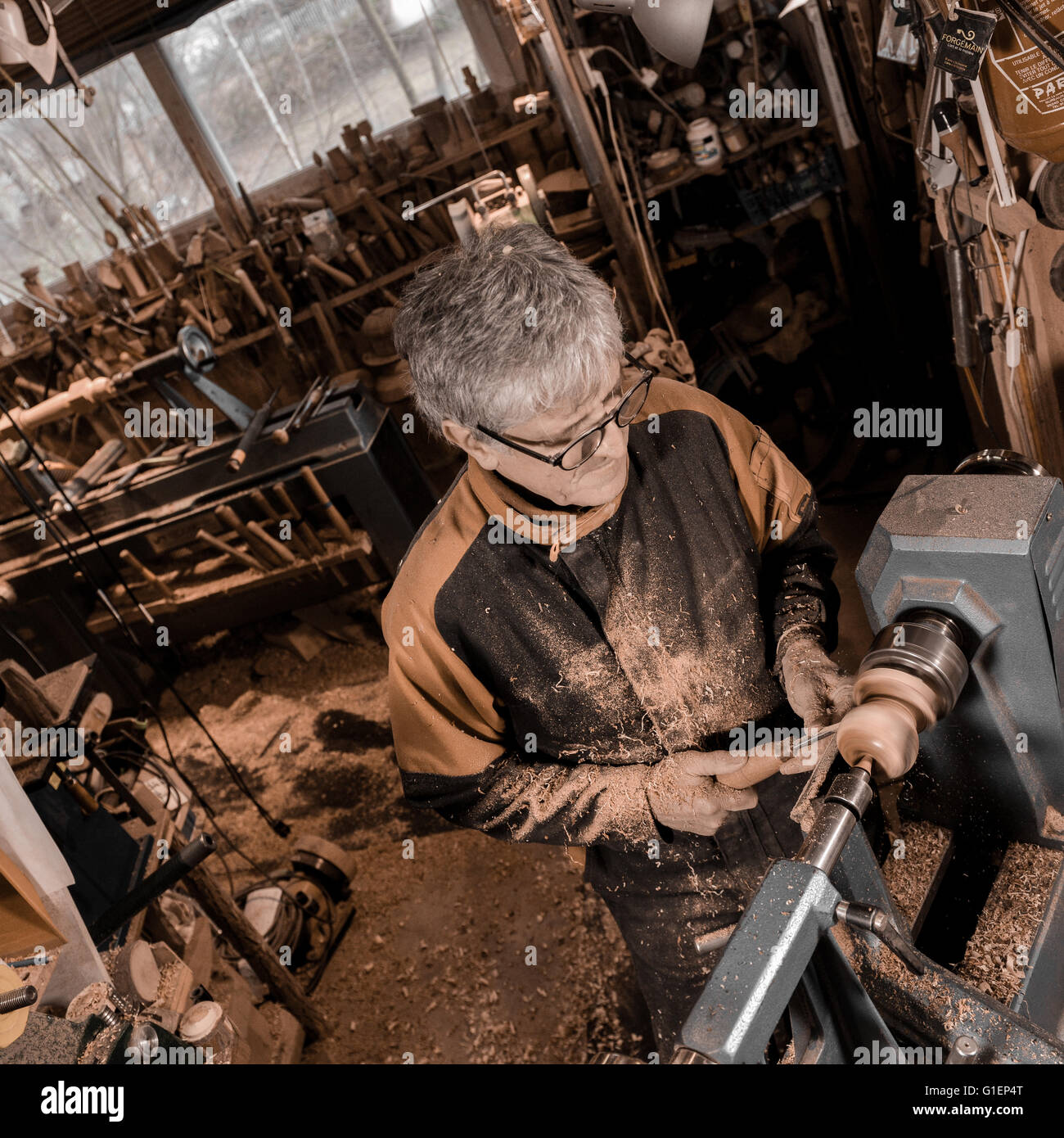Wood turners using a rotating clamp to turn the wood, France Stock ...