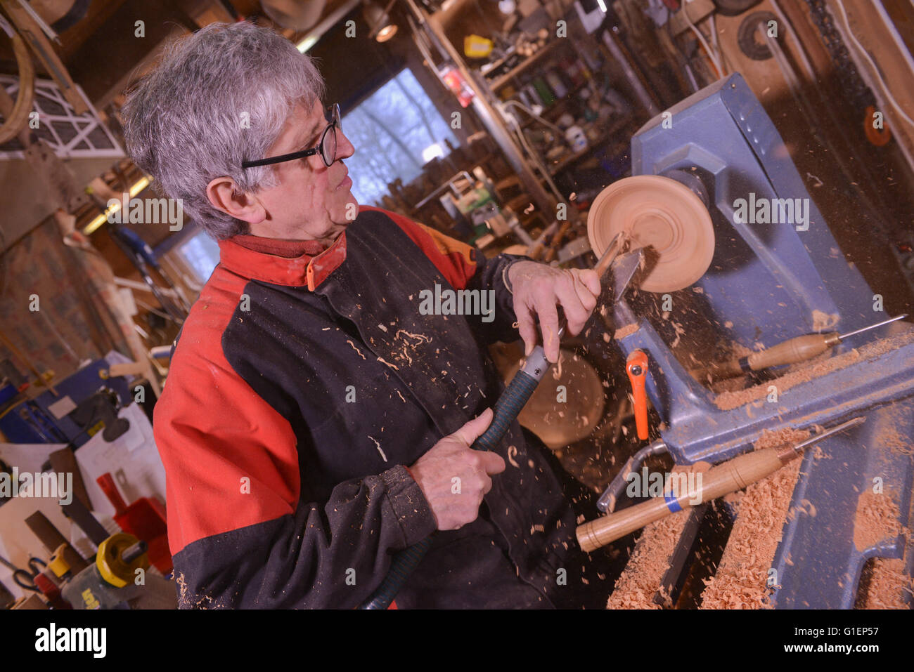 Wood turners using a rotating clamp to turn the wood, France Stock ...