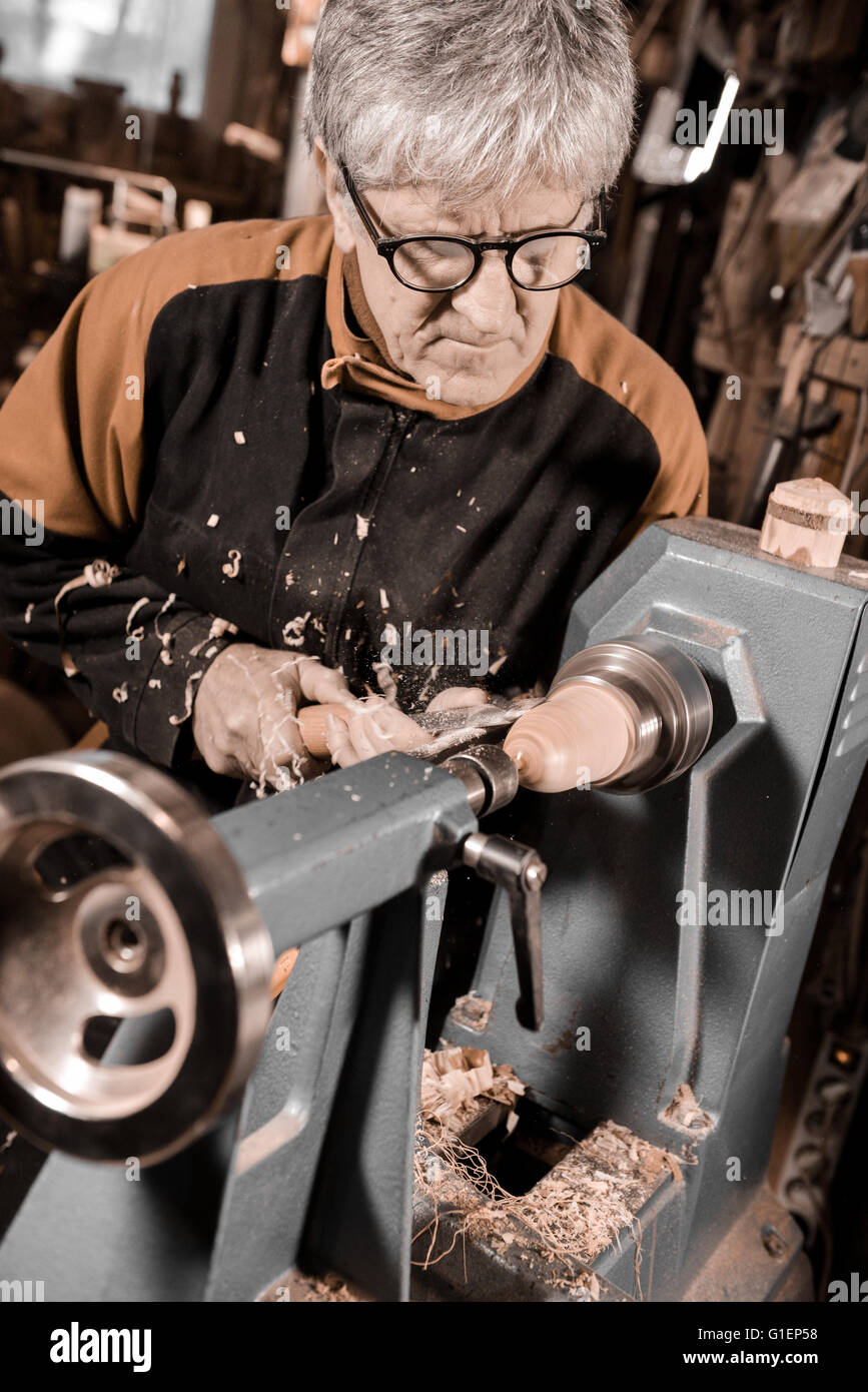 Wood turners using a rotating clamp to turn the wood, France Stock ...